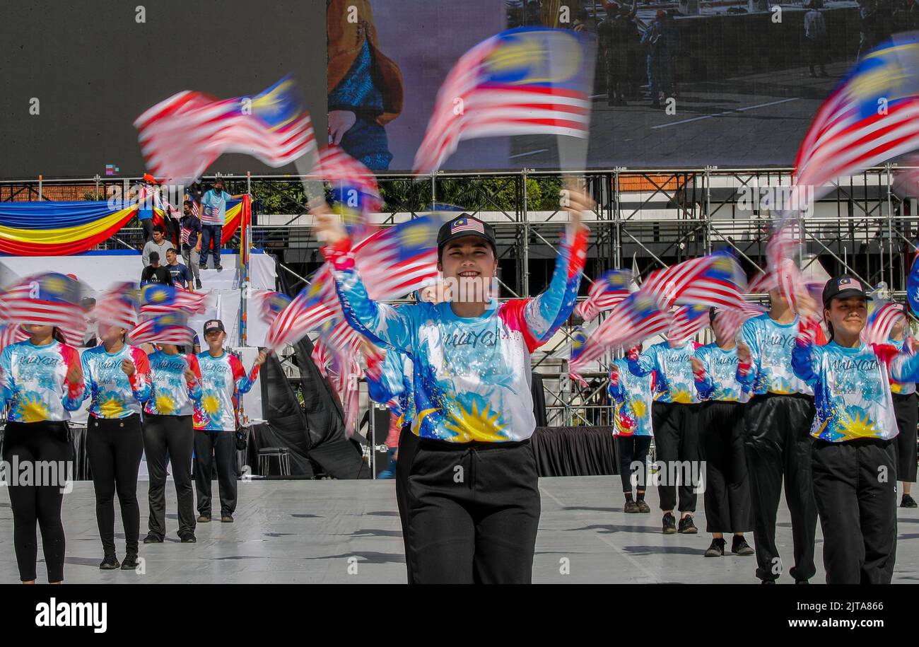 Malaysian students wave national flags of Malaysia during the 65th ...