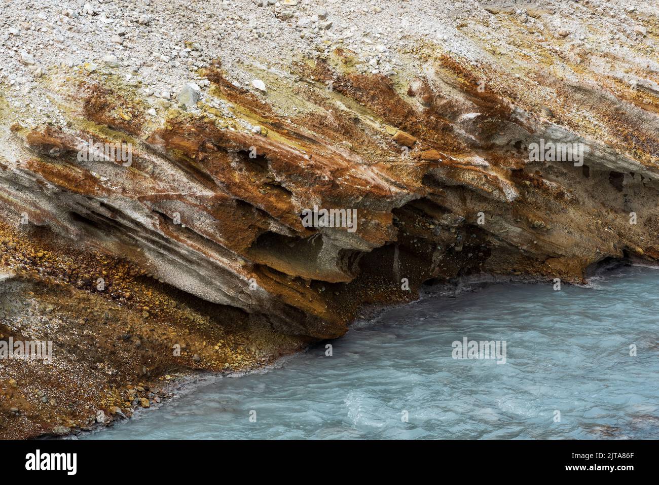 hydrothermal mineralised stream flowing on the slope of the volcano ...