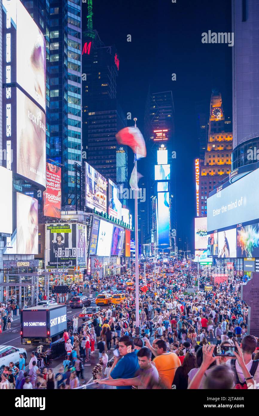 Large crowds gathered by night in Times Square in Midtown Manhattan ...