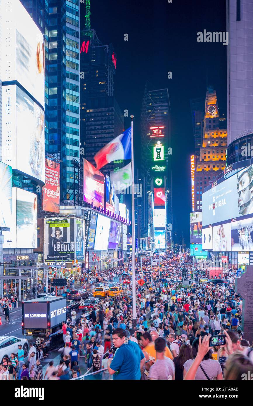 Large crowds gathered by night in Times Square in Midtown Manhattan ...