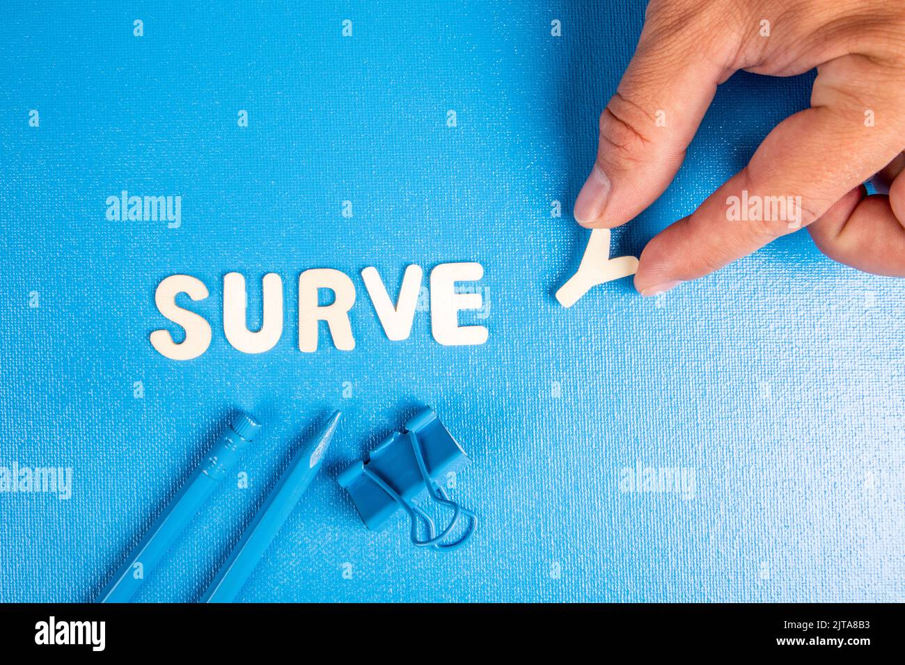 Survey concept. Text from white wooden letters on a blue background ...