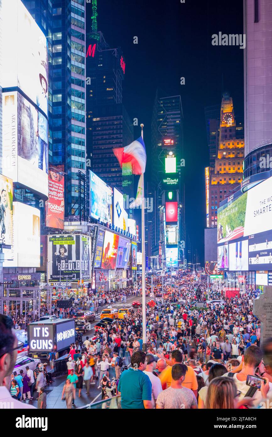 Large crowds gathered by night in Times Square in Midtown Manhattan ...