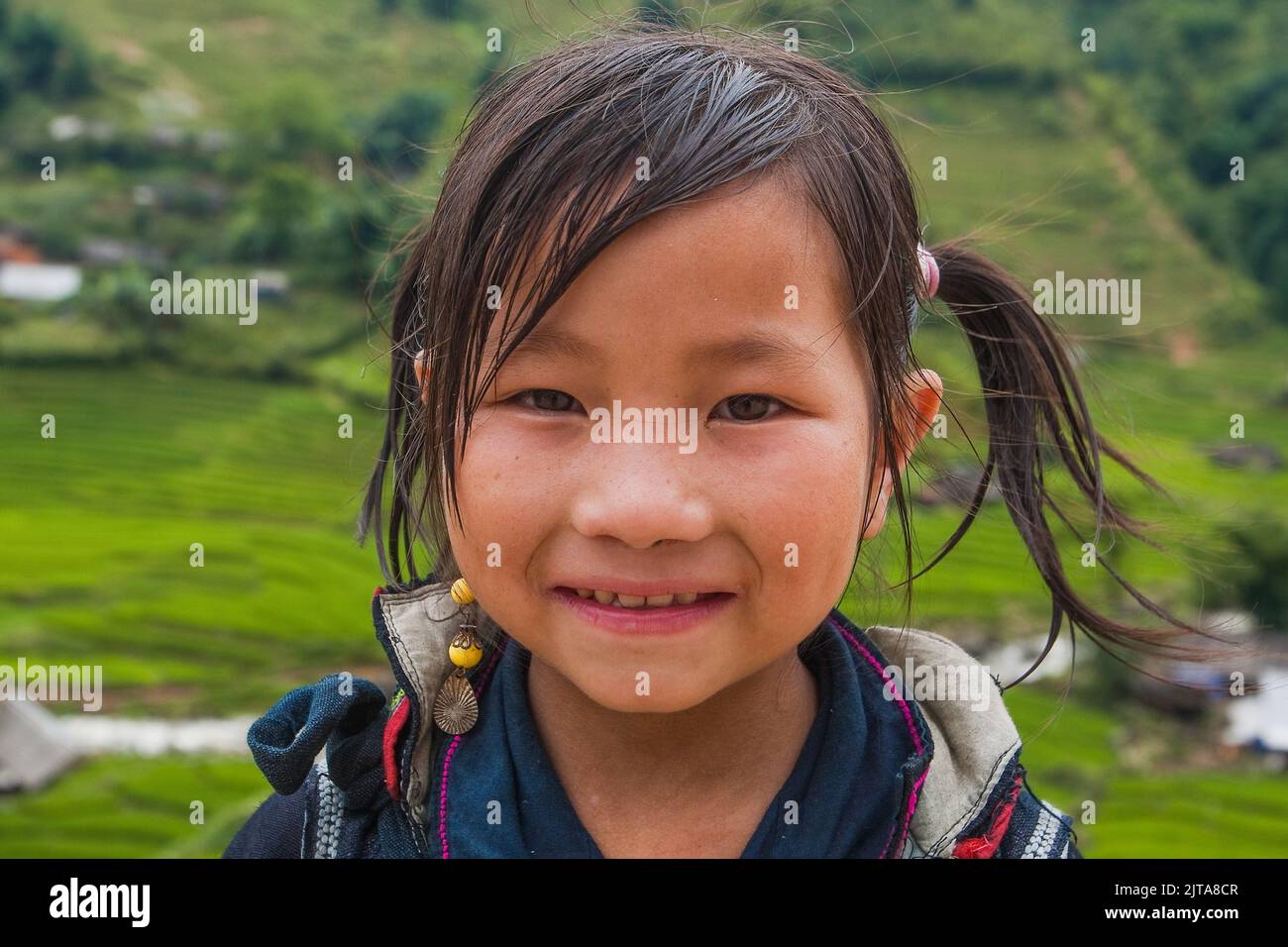 Vietnam, Sapa region. Portrait of a little girl of the Hmong hill tribe ...