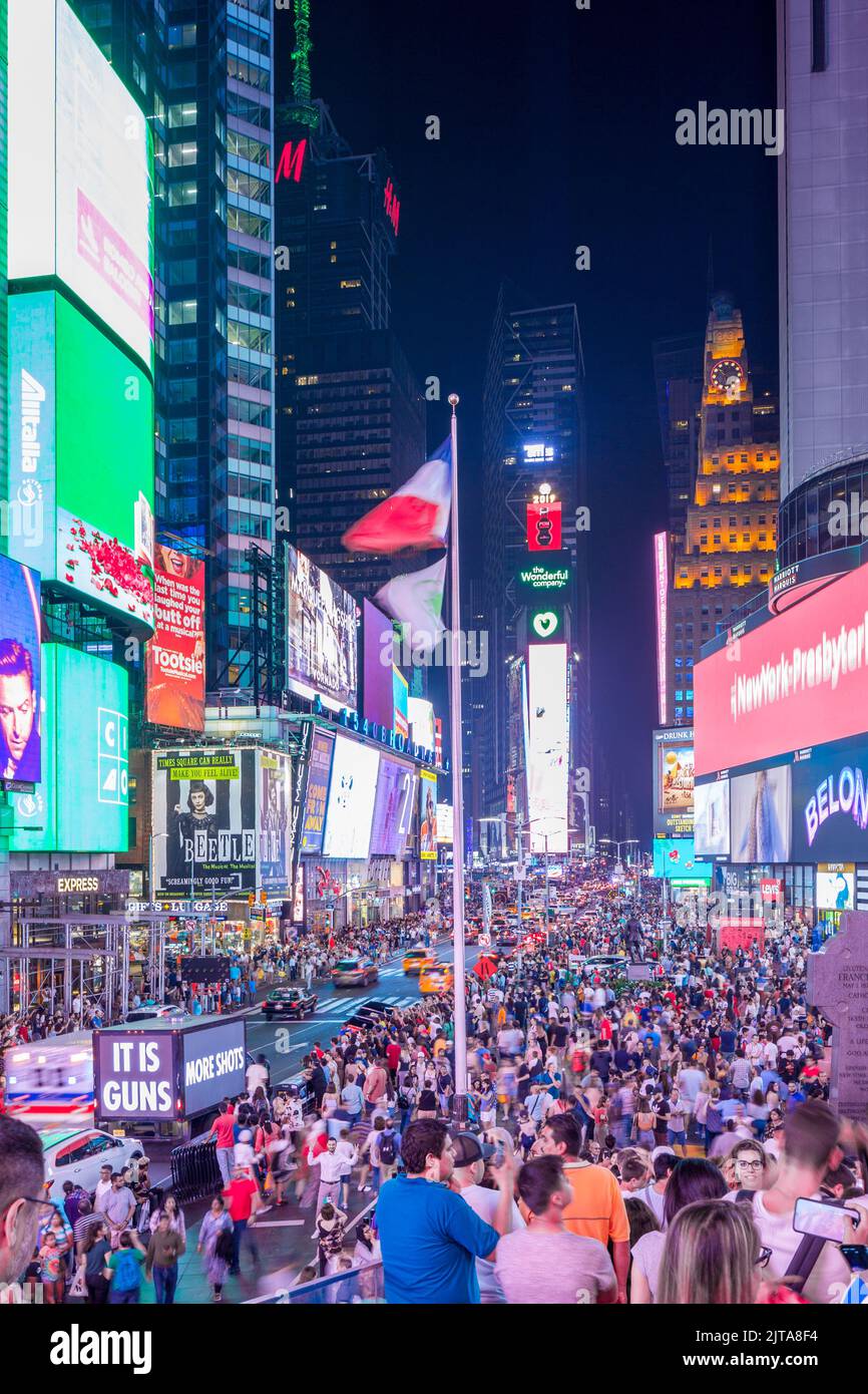 Large crowds gathered by night in Times Square in Midtown Manhattan ...