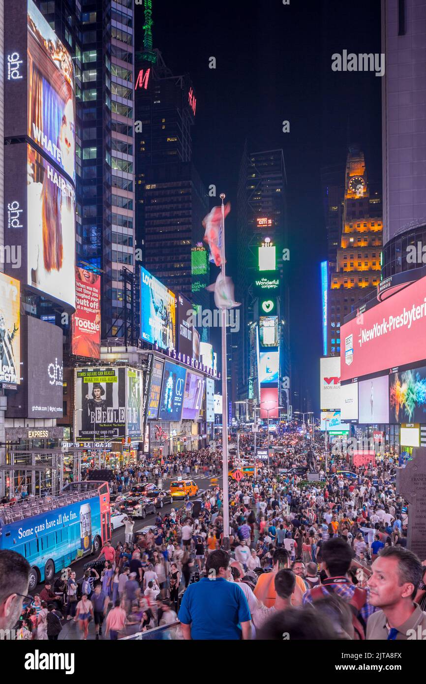 Large crowds gathered by night in Times Square in Midtown Manhattan ...