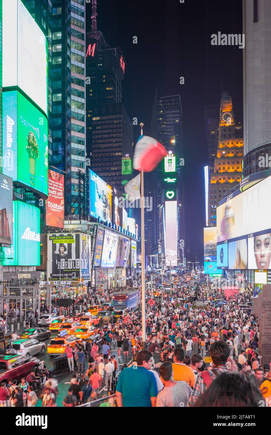 Large crowds gathered by night in Times Square in Midtown Manhattan ...