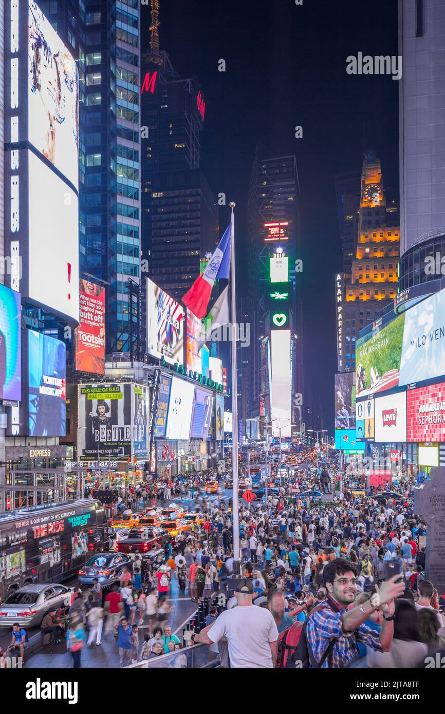 Large crowds gathered by night in Times Square in Midtown Manhattan ...