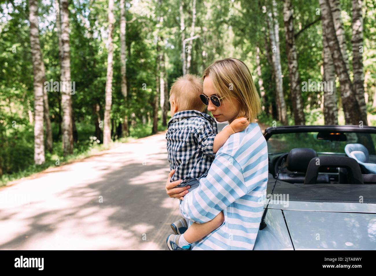 Mom and little son in a convertible car. Summer family road trip to ...