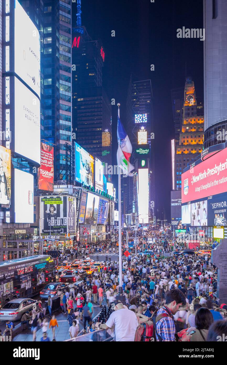 Large crowds gathered by night in Times Square in Midtown Manhattan ...