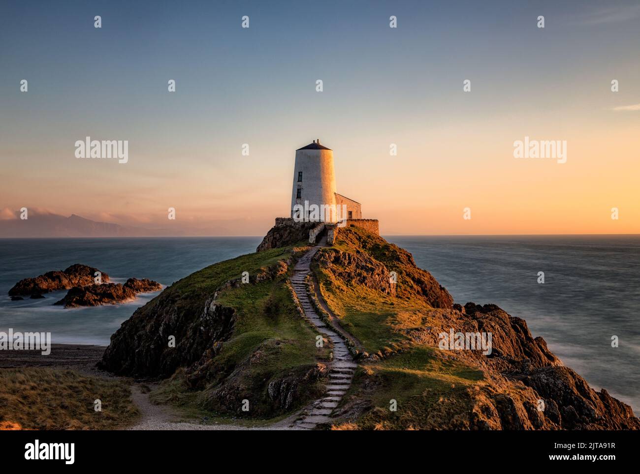 The beautiful view of Llanddwyn Lighthouse at sunset. Wales, UK Stock ...