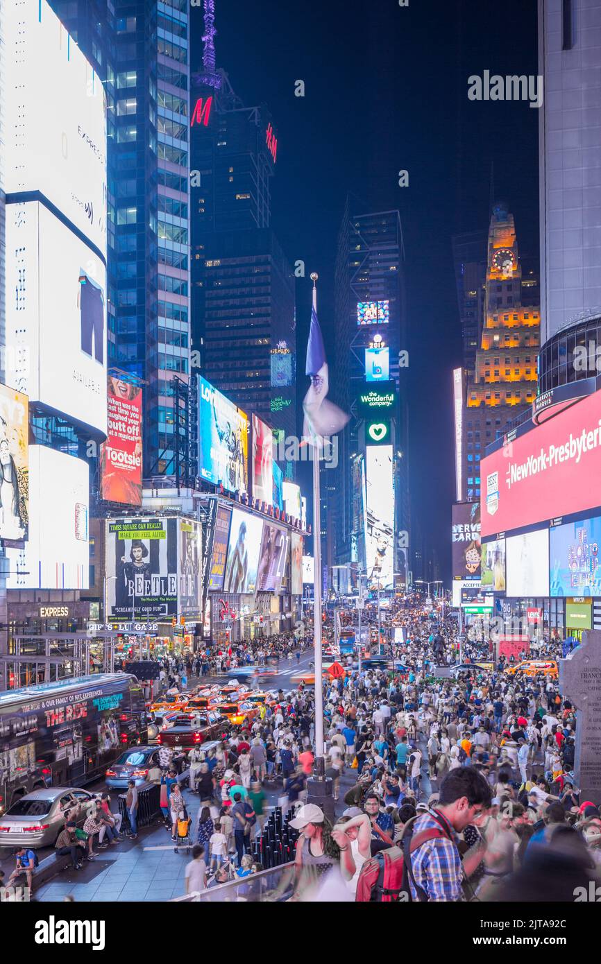 Large crowds gathered by night in Times Square in Midtown Manhattan ...