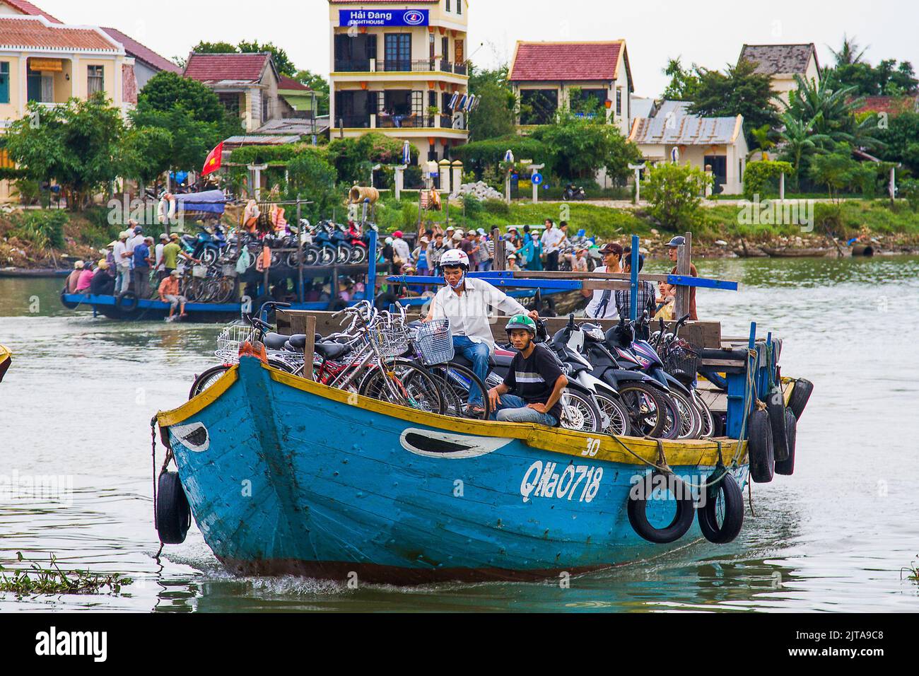 Vietnam, Hoi An Ferry boat bringing people and their mopeds to one of ...