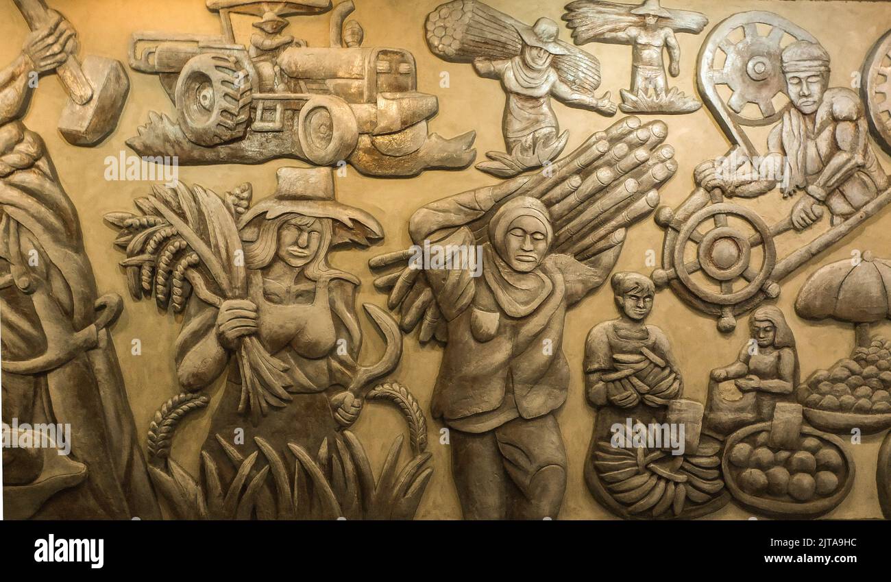 A relief brass sculpture depicts the diligence of Filipino farmers. As ...