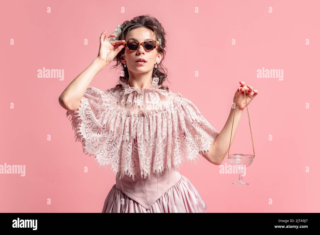 Fashion. One young fashionable woman with retro style hairdo wearing ...