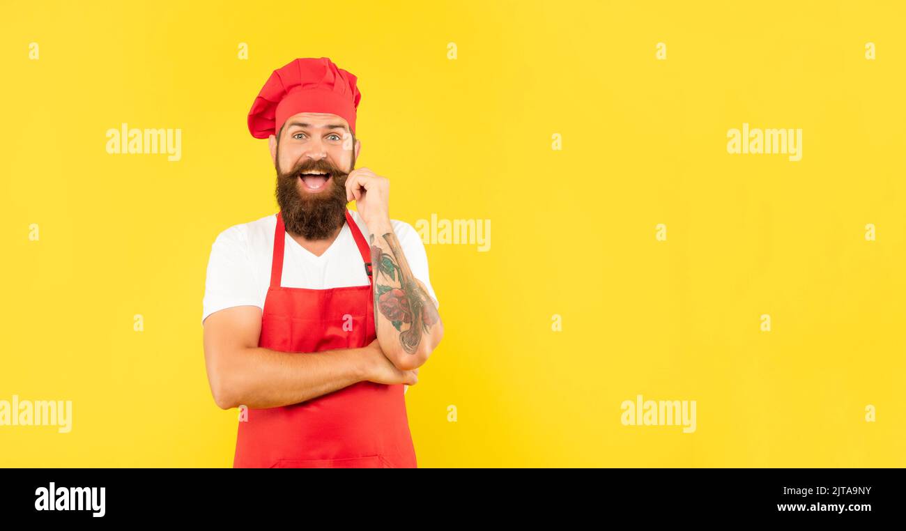 Happy man in red toque and apron twirling moustache yellow background ...