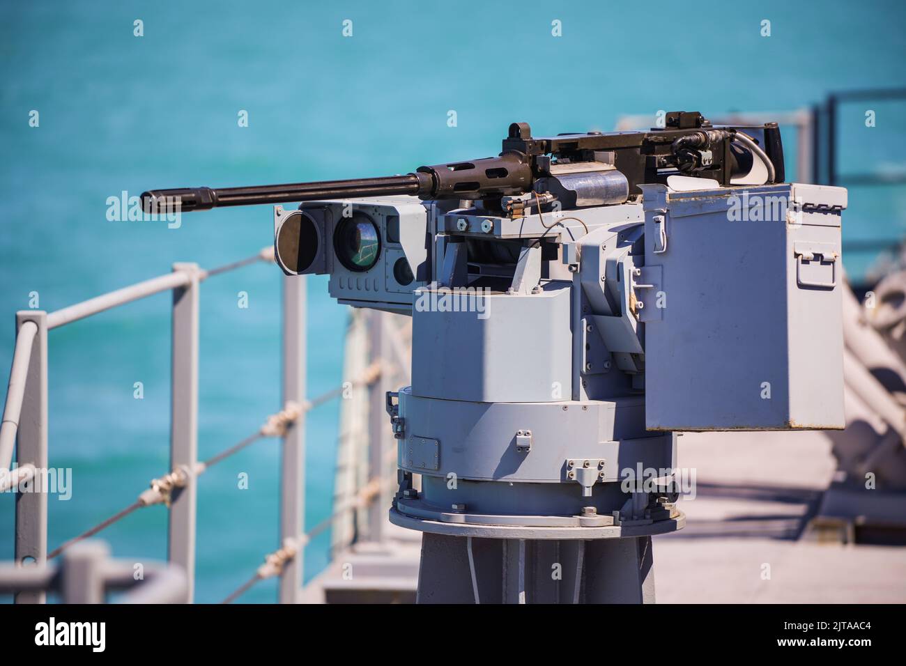 Color image of an automated machine gun on the deck of a military ship ...