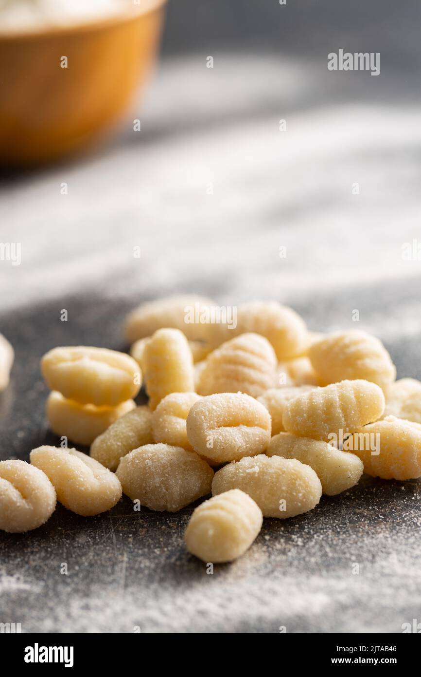 Uncooked potato gnocchi on a kitchen table. Tasty italian food Stock ...