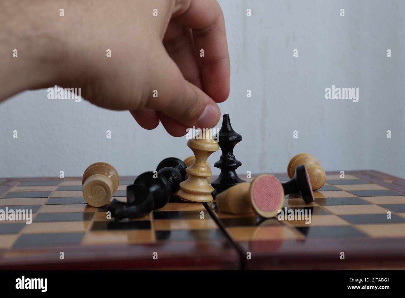 Player surprised by making a move on the chessboard Stock Photo - Alamy