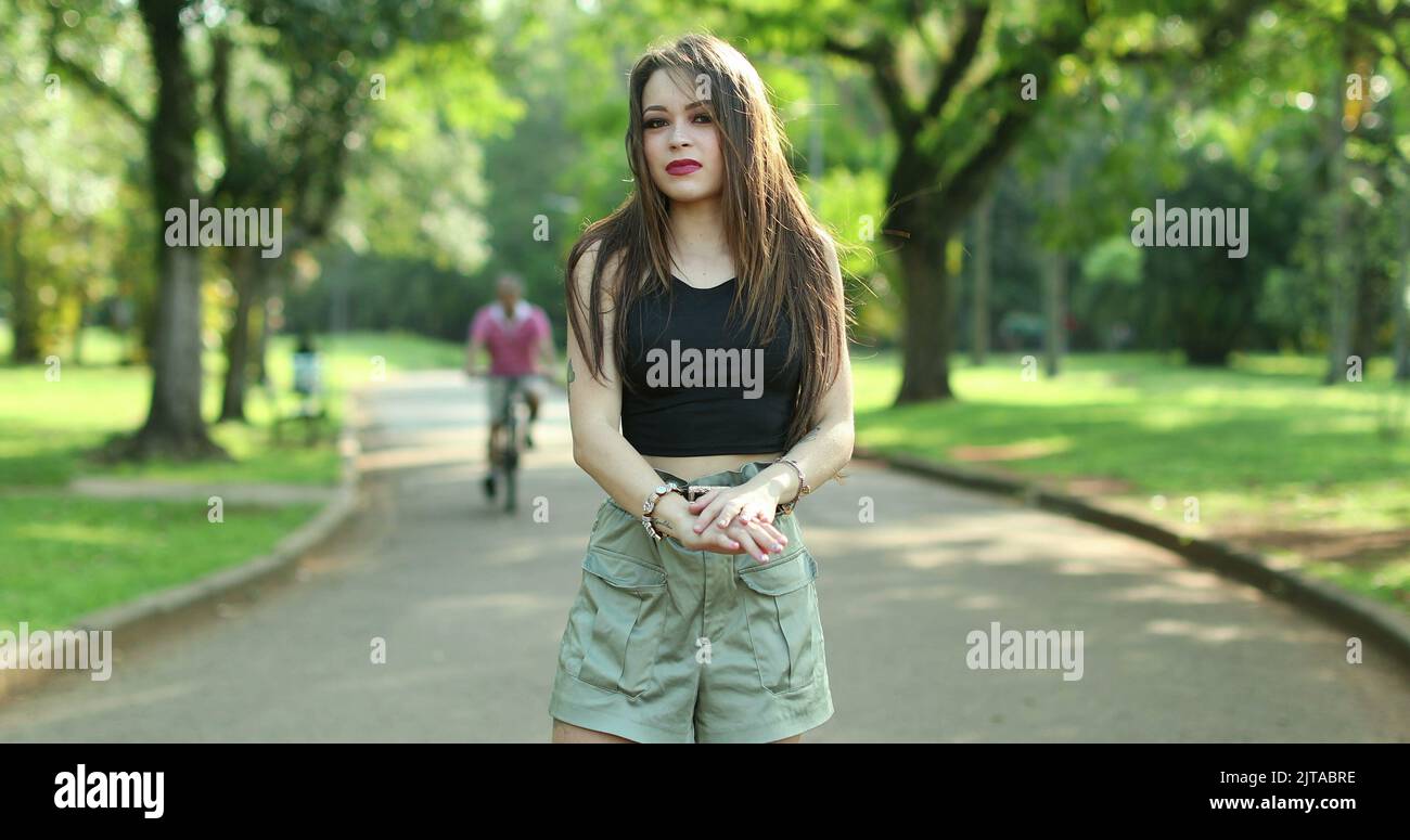 Annoyed confused millennial girl raising arms in disbelief in outdoor ...