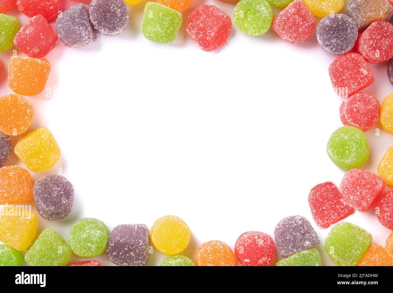 Frame of colorful gum drop candies over whute background with copy ...