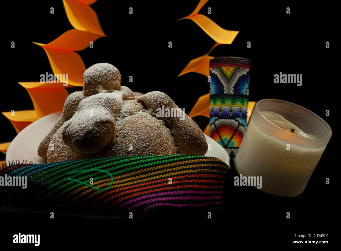 bread decorated with simulated crossbones and sugar placed on an altar ...