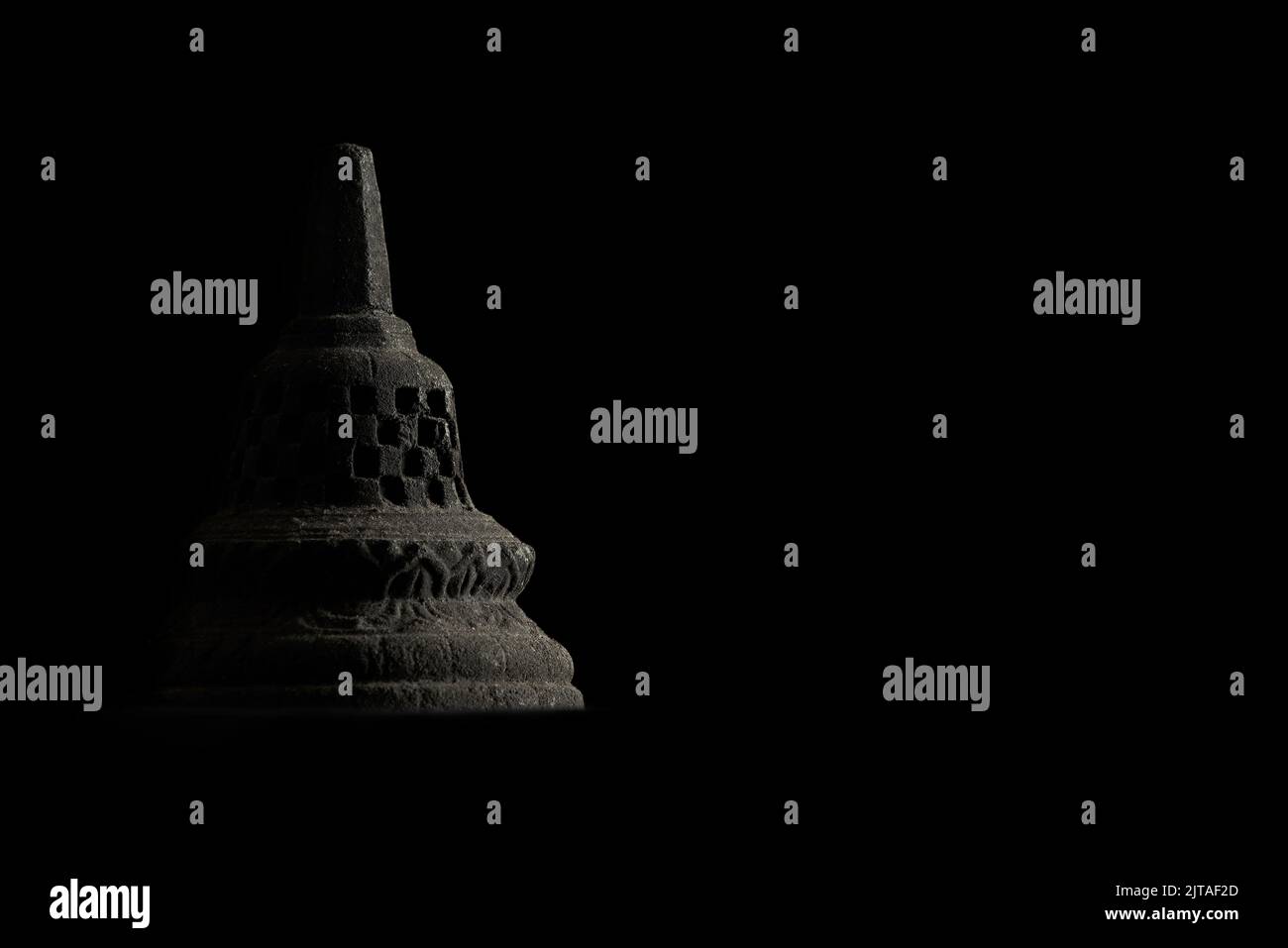 Miniature stupa made of temple stone with low key dramatic lighting ...