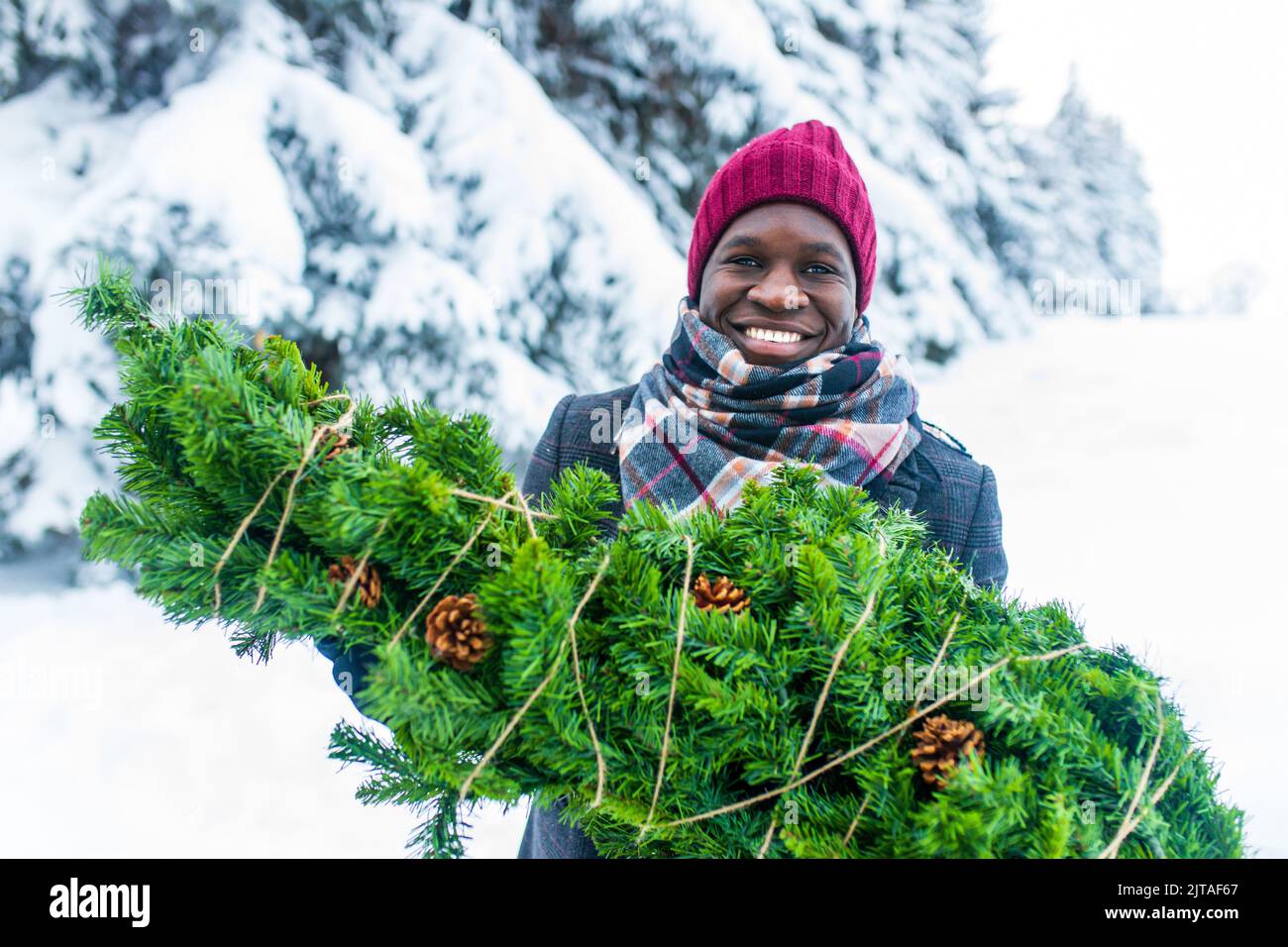 latin hispanic man in red hat , scarf and stylish coat carrying eco ...