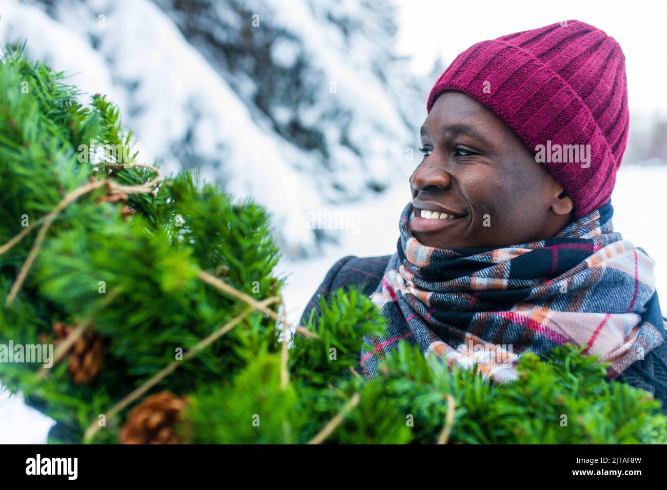 latin hispanic man in red hat , scarf and stylish coat carrying eco ...