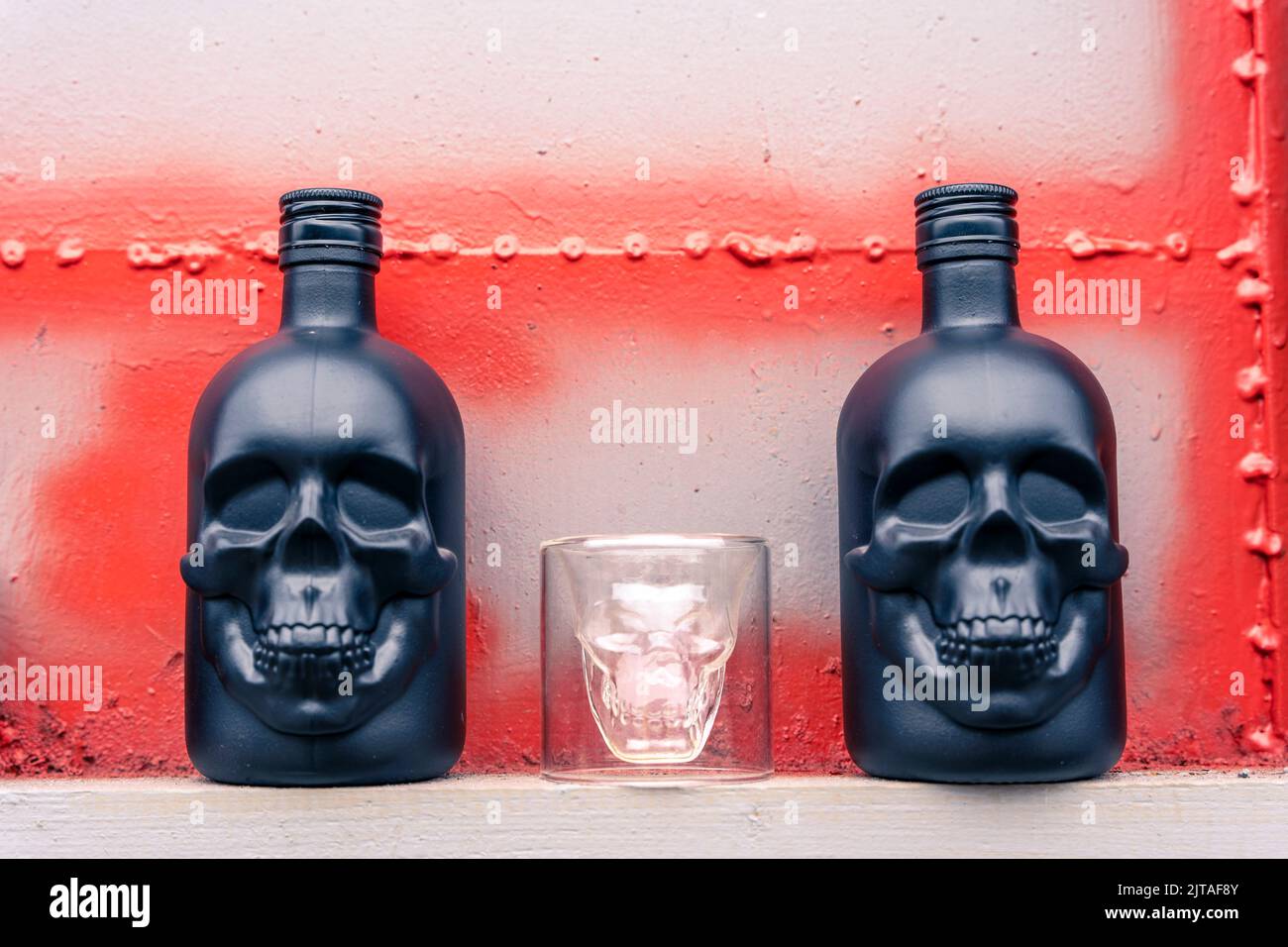 glass gin bottles in the shape of a human skull and a glass stack Stock ...