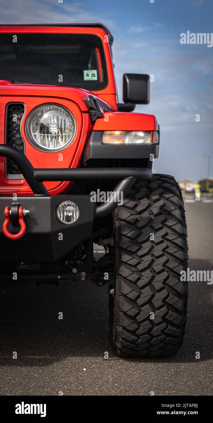 A red off road vehicle on a driveway Stock Photo - Alamy