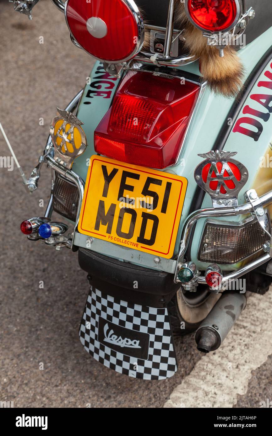 The back of a mod scooter with lots of lights and badges Stock Photo ...