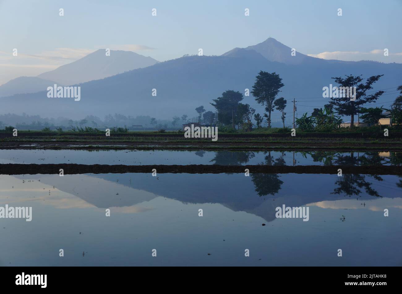 Reflection of Merbabu and Telomoyo mountains in Semarang, Indonesia on ...
