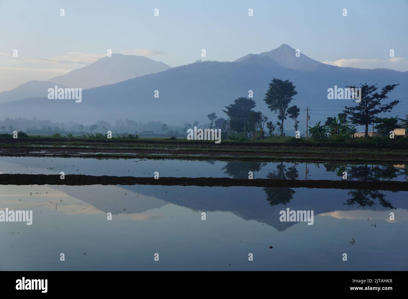 Reflection of Merbabu and Telomoyo mountains in Semarang, Indonesia on ...