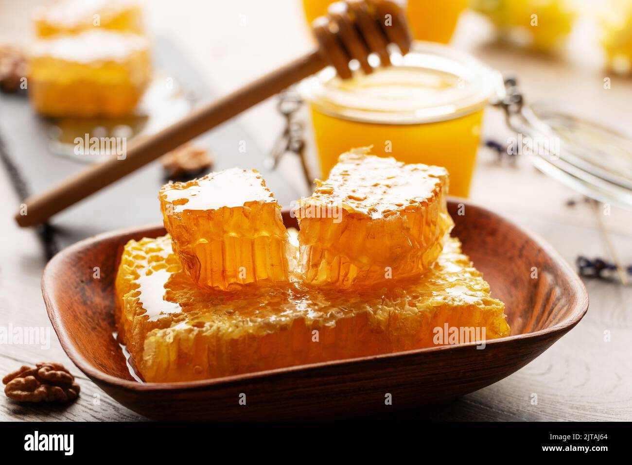 Honeycomb on slate tray with honey and nuts on kitchen table Stock ...