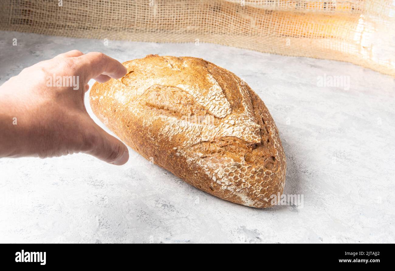 Man's hand taking a bread. Bakery and food concept Stock Photo - Alamy