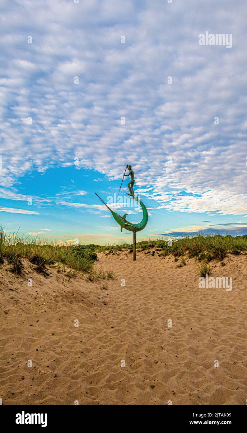 A sculpture of a swordfish harpooner near a beach in the United States ...