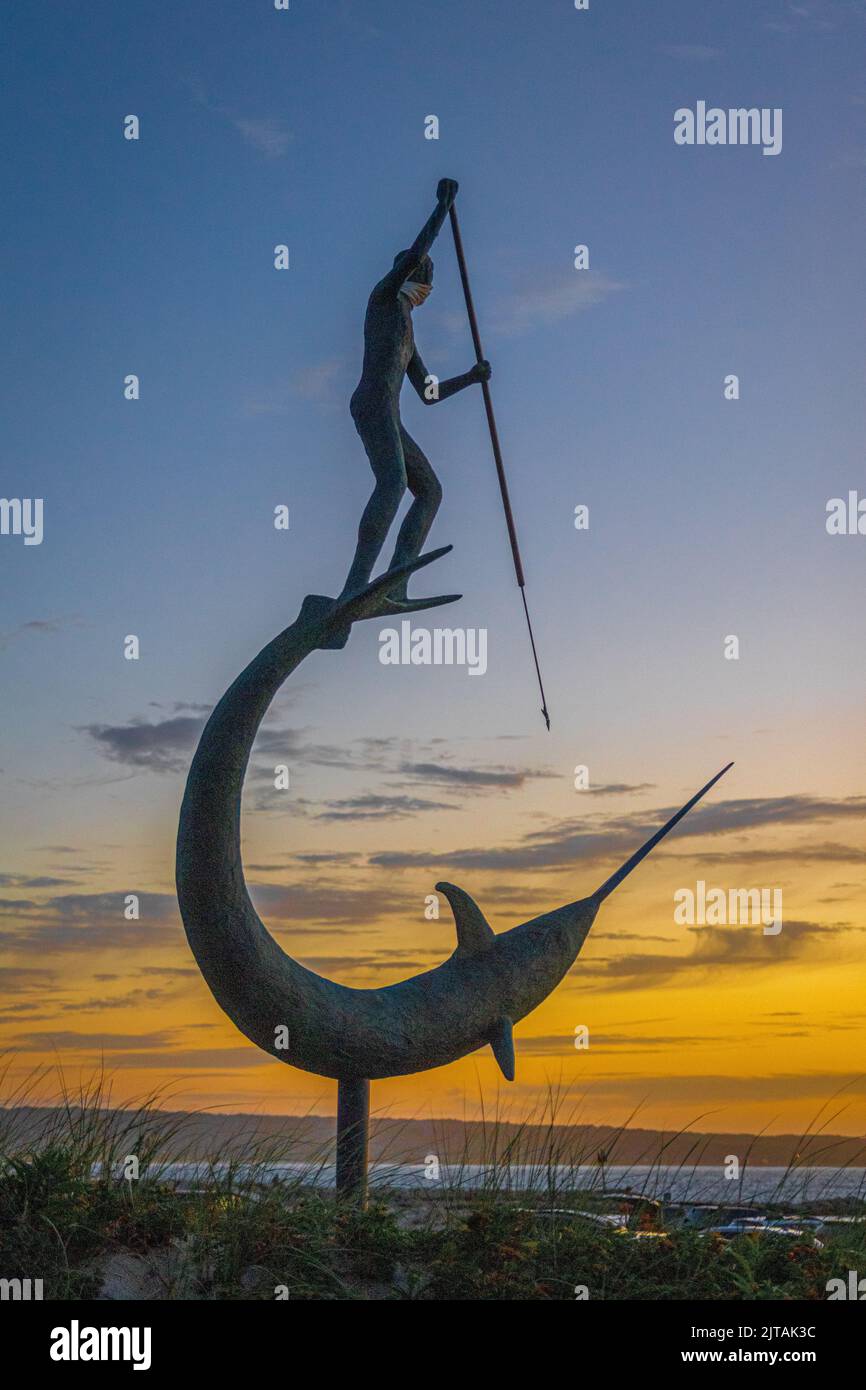 The sculpture of the swordfish harpooner during the sunset in the ...