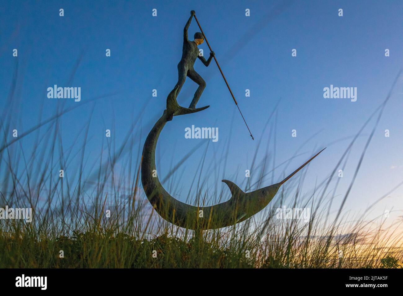 The sculpture of the harpooner during the sunset in the Marthas ...