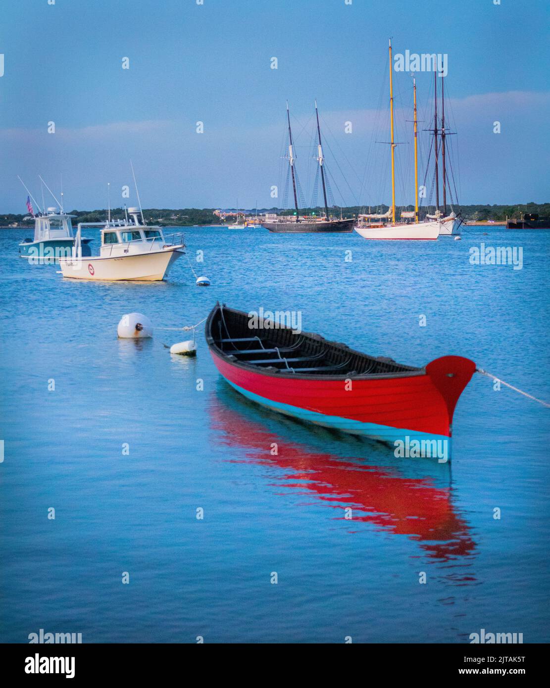 A row boat sitting off a beach in a harbor Stock Photo - Alamy