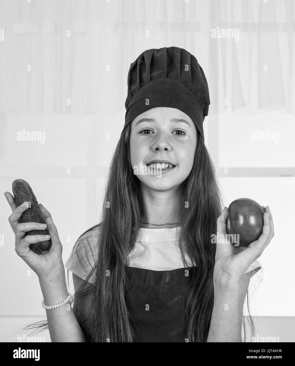 teen girl in cook uniform prepare food in kitchen, vegetables Stock ...