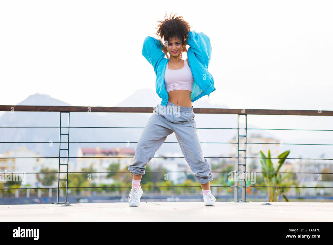multicultural race curly woman enjoying dance at sunset in beach Stock ...