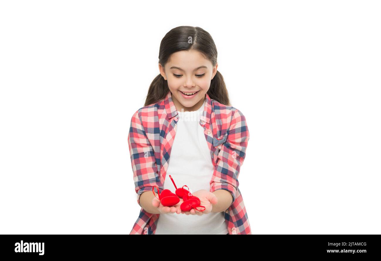 Small girl holding hearts toys. Cute girl with red hearts love. Child ...