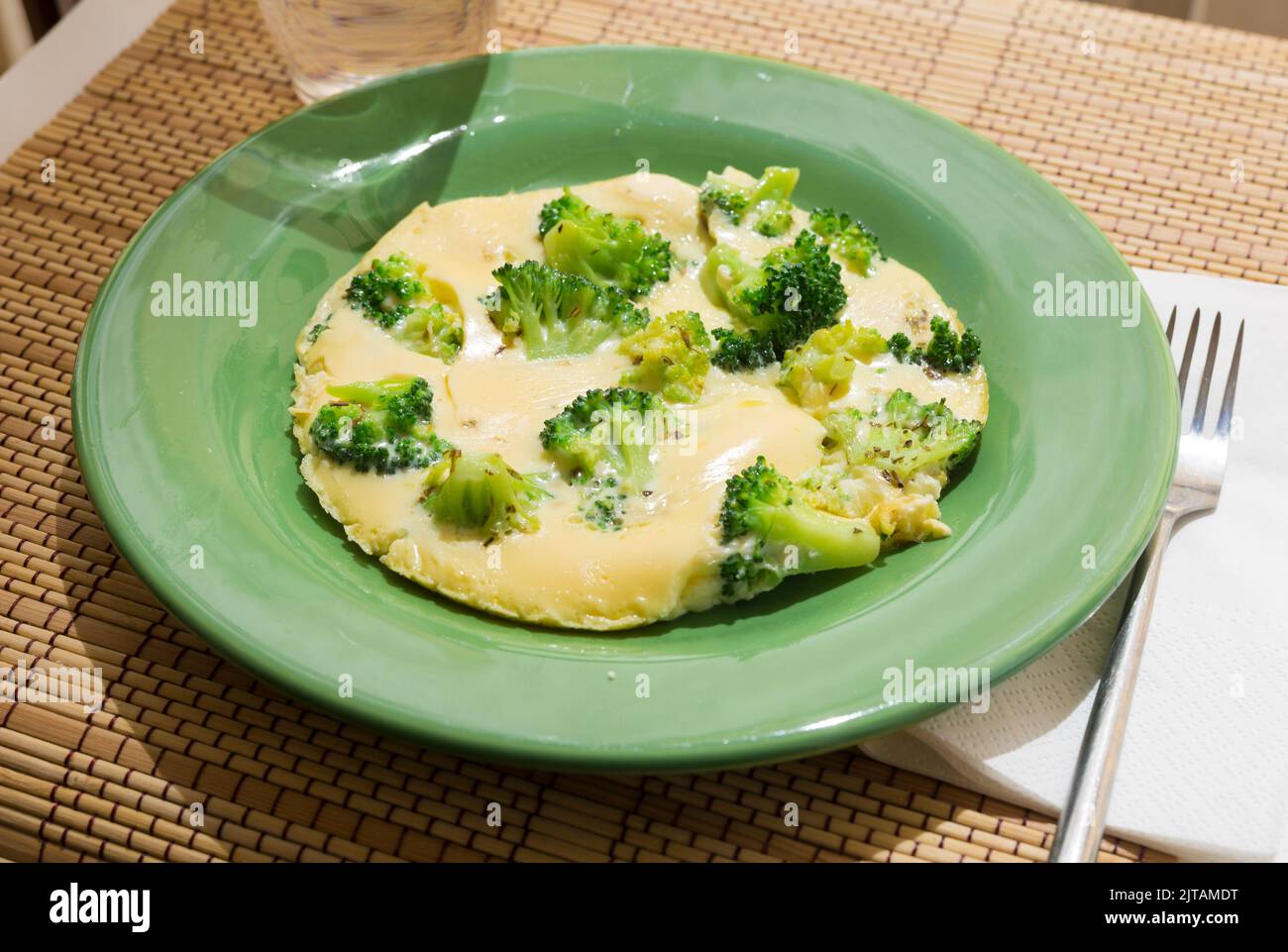 wholesome breakfast. omelet with broccoli on green plate Stock Photo ...