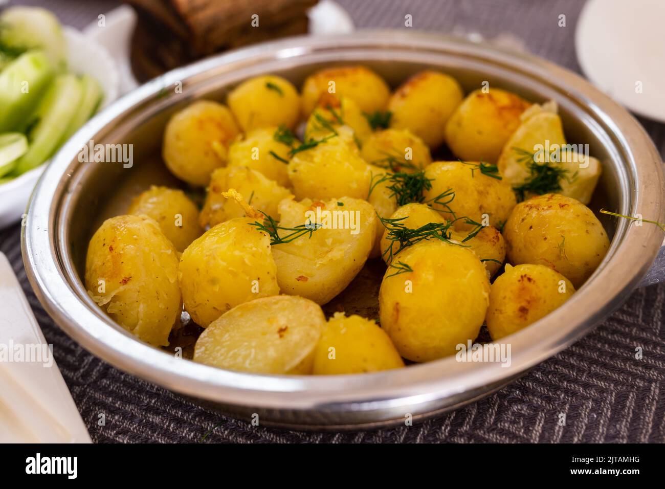 toasted young potatoes with dill in metal skillet Stock Photo - Alamy