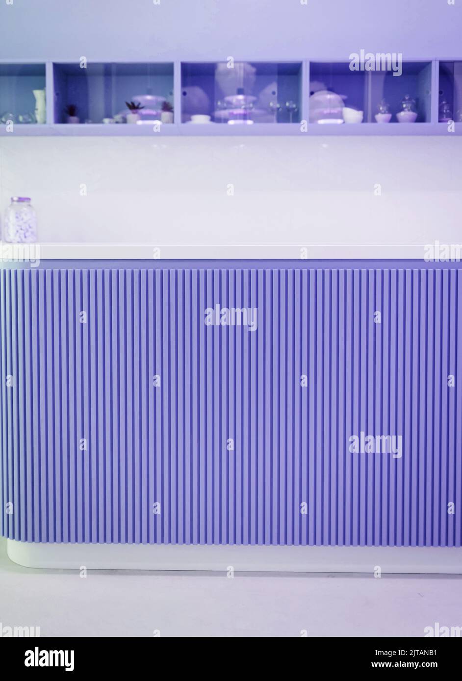 Stylish blue kitchen interior with dining table Stock Photo - Alamy