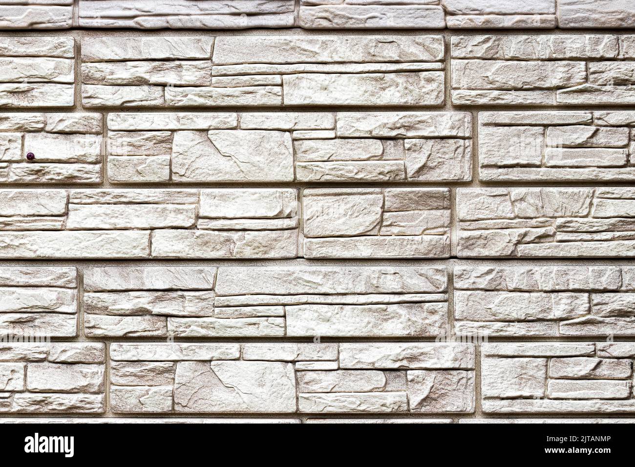 Texture of a wall covered with decorative brick-like tiles. Abstract ...