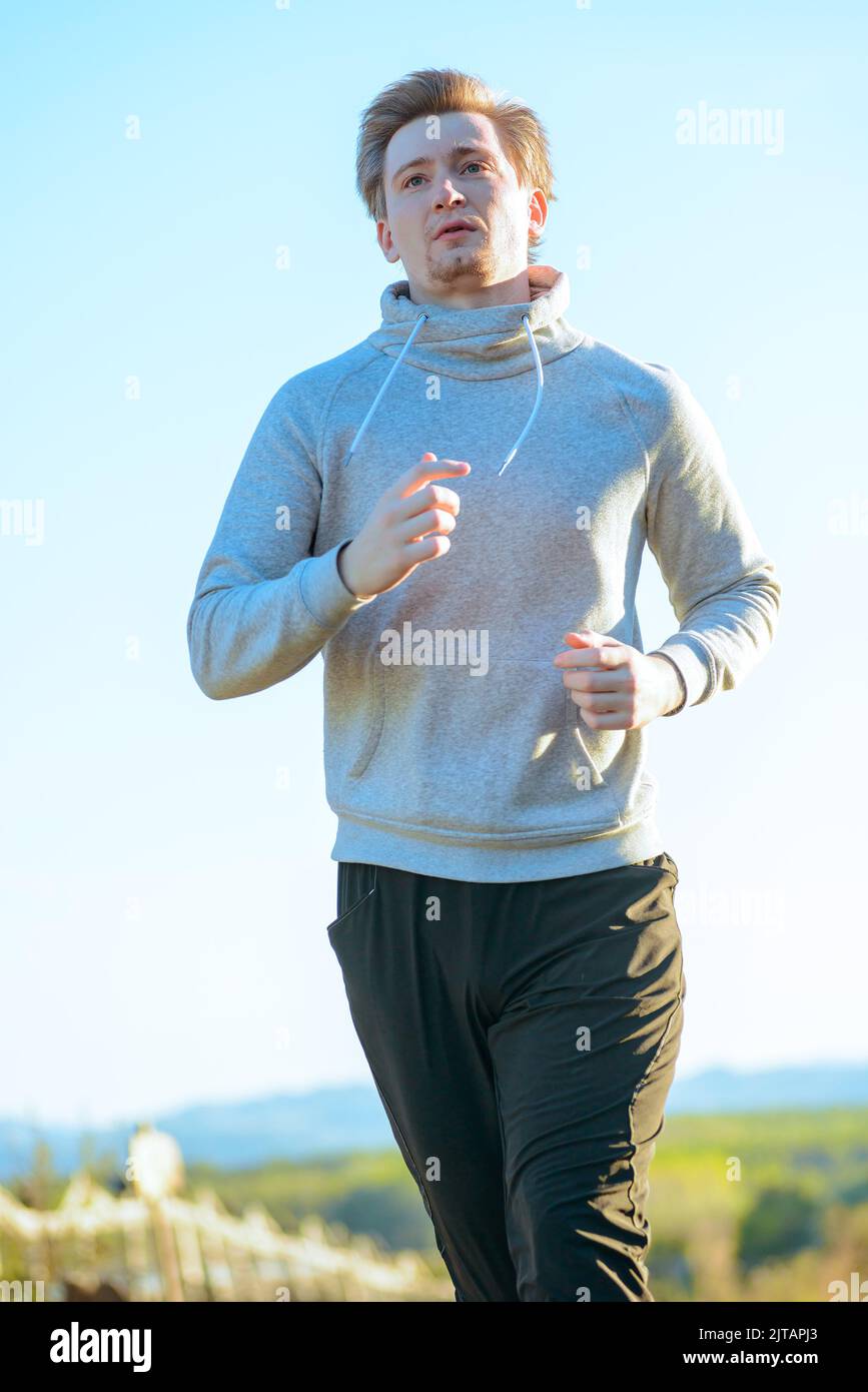 Running man jogging in rural nature at beautiful summer day. Sport ...