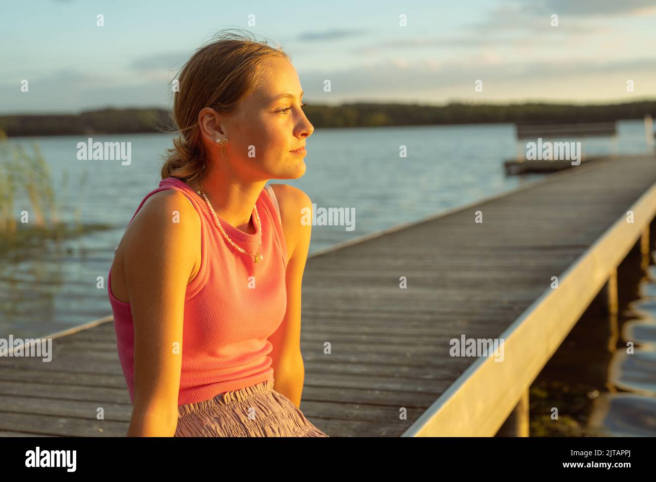 beautiful teenage girl side view portrait sitting outdoor with copy ...