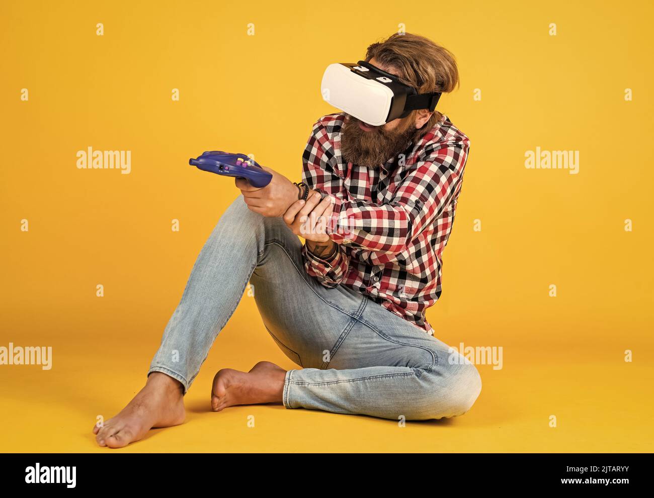 play the game. guy getting experience using VR-headset glasses. bearded ...