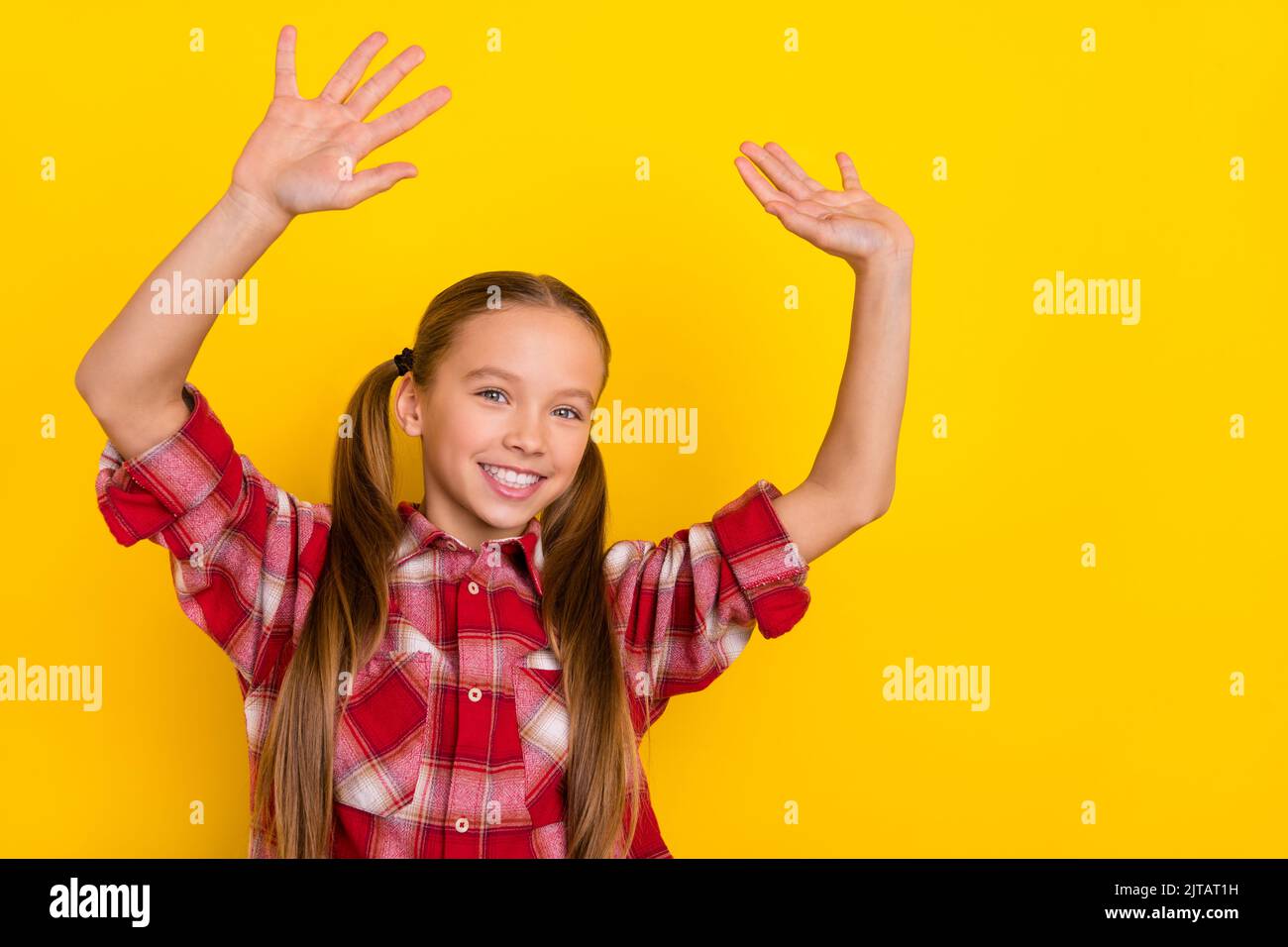 Photo of cute sweet schoolgirl wear checkered shirt rising arms empty ...
